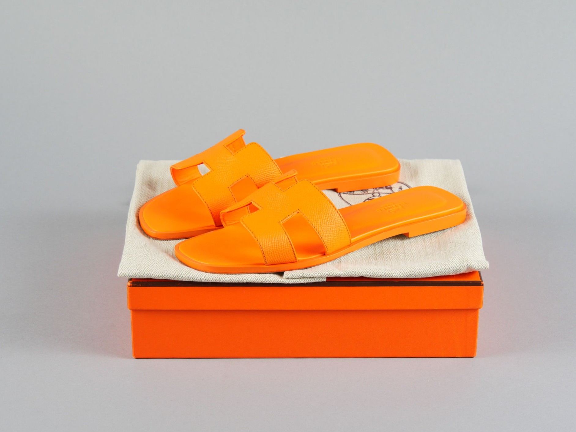 HERMES Paris. Oran model. Pair of orange leather mules... | Shoes: bids