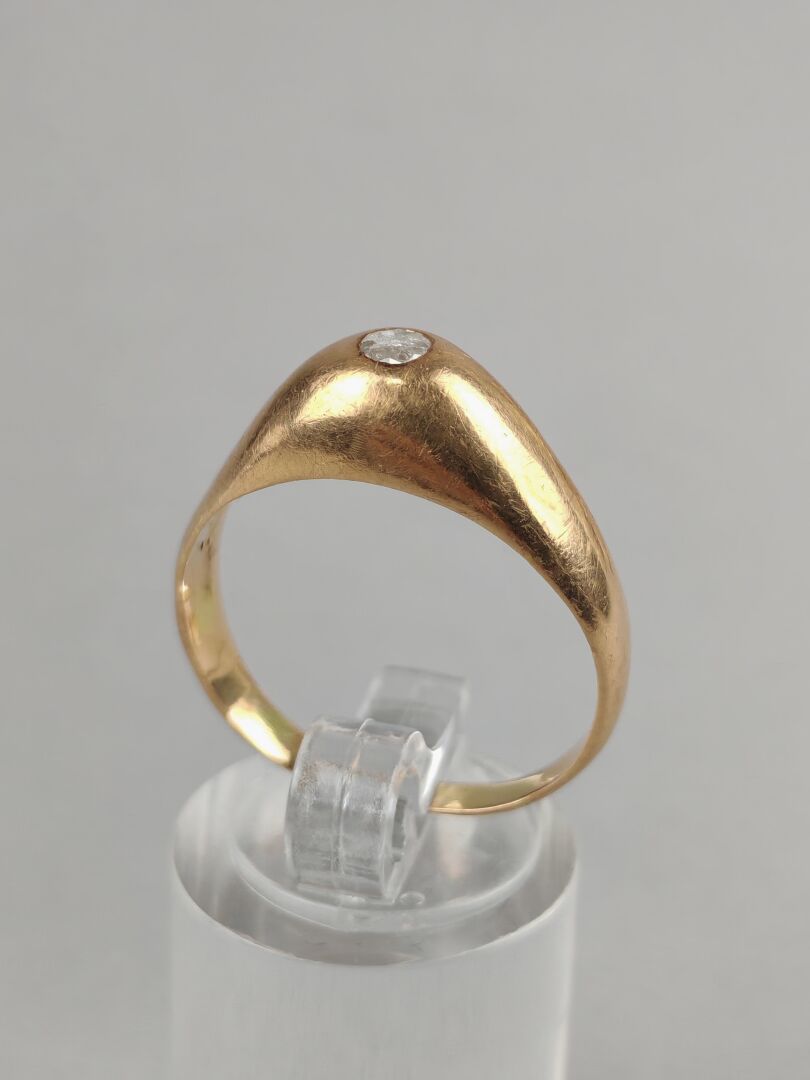 Yellow gold English band ring set with a white stone. ... | Rings: bids